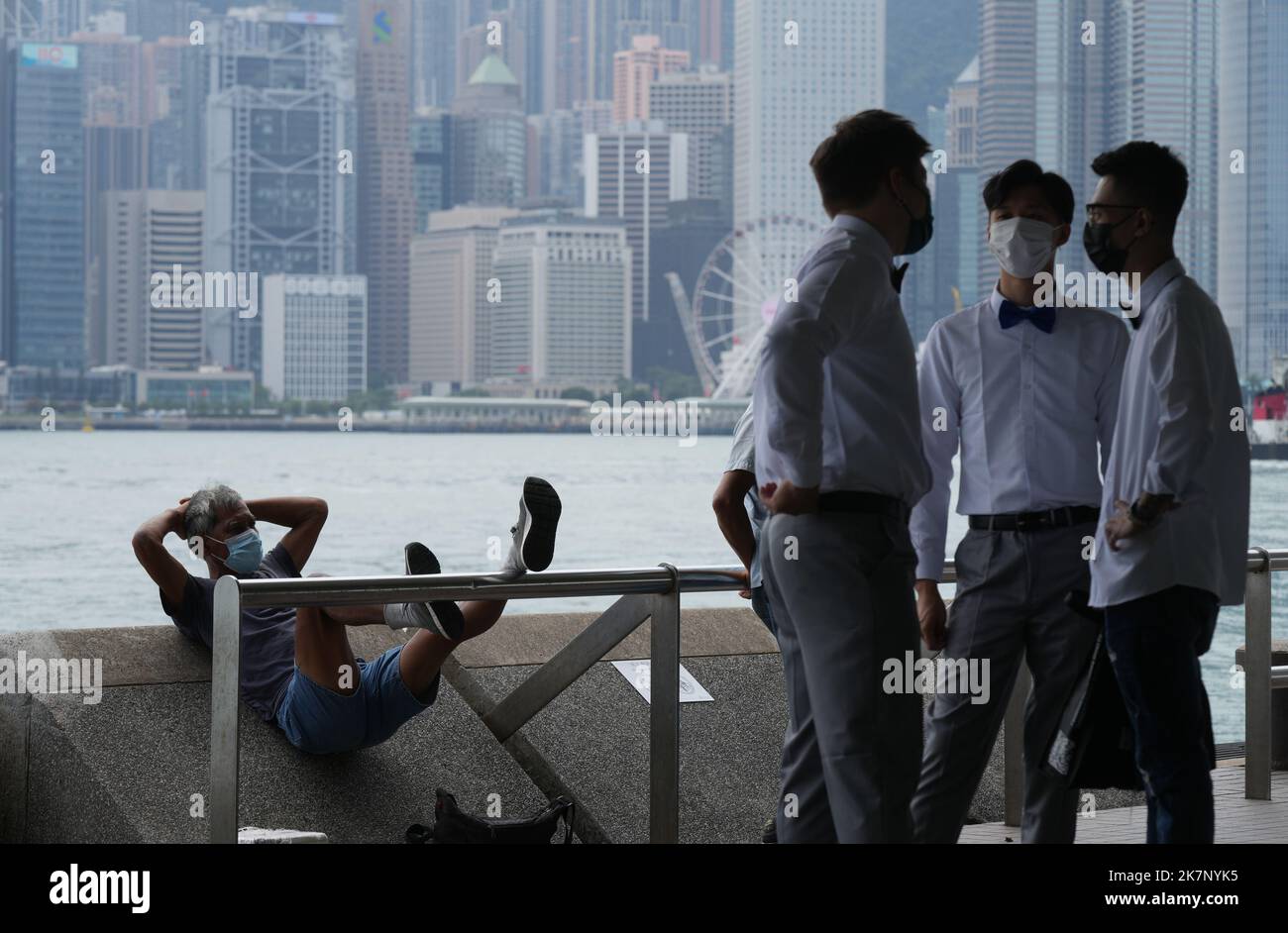 People (including groomsman) taking rest at the waterfront of Victoria ...