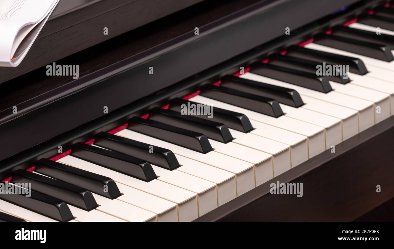 Electronic piano keyboard with white sheet music Stock Photo - Alamy