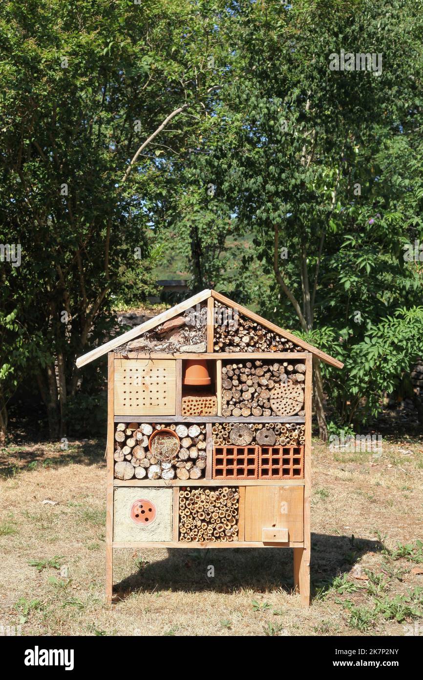 Insect hotel in a garden Stock Photo - Alamy