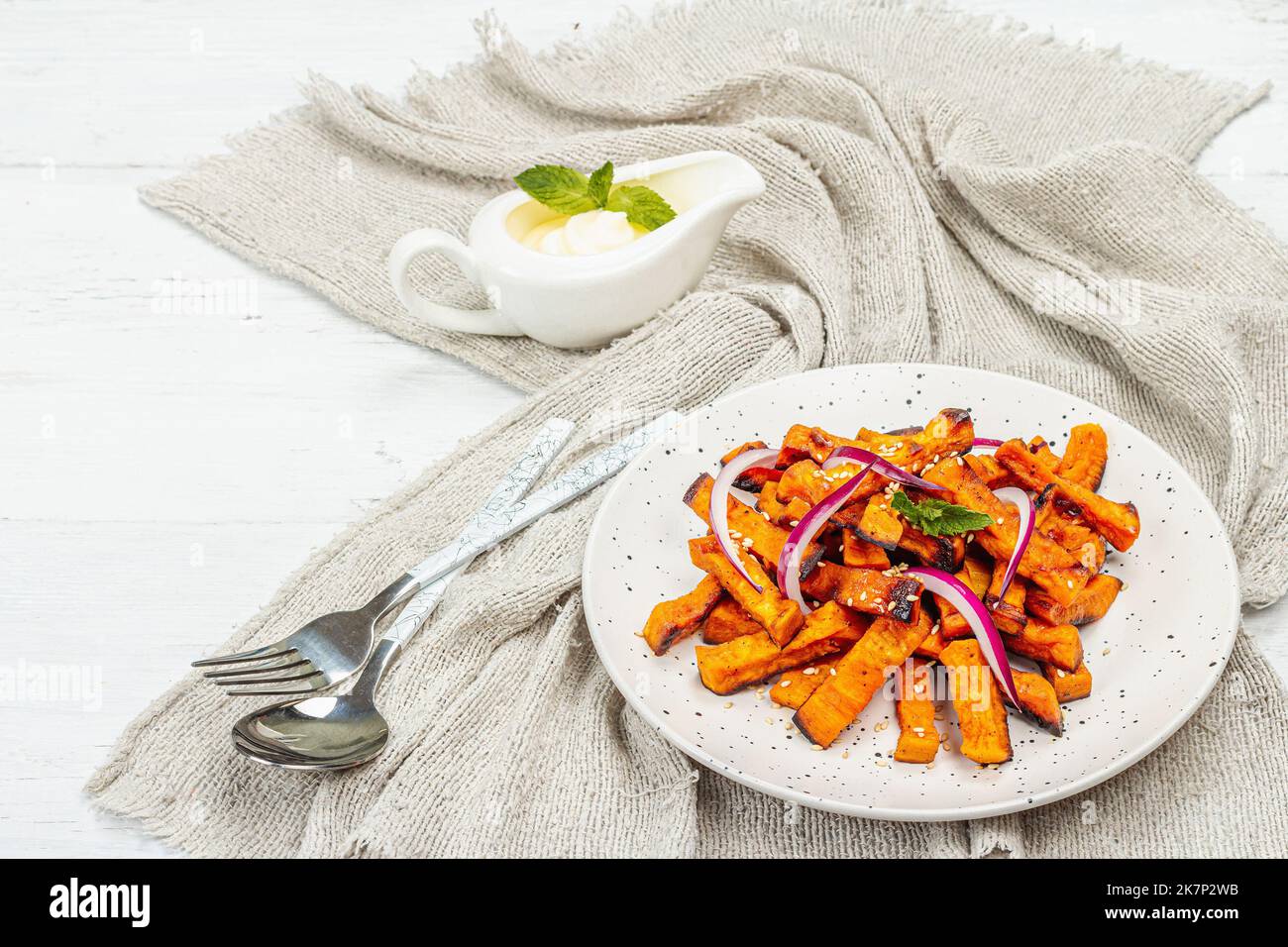 Baked organic batata fries with spices and sauce. Sweet vegetable ...