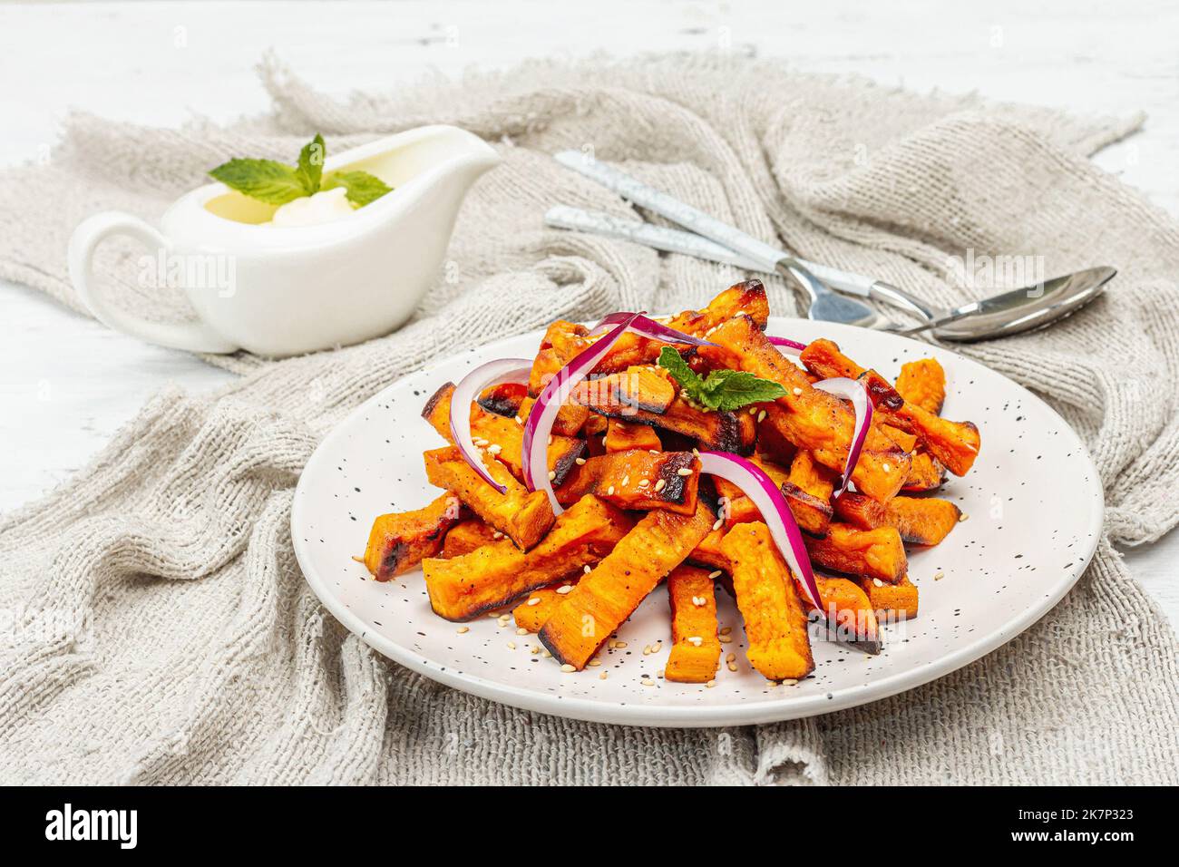 Baked organic batata fries with spices and sauce. Sweet vegetable ...