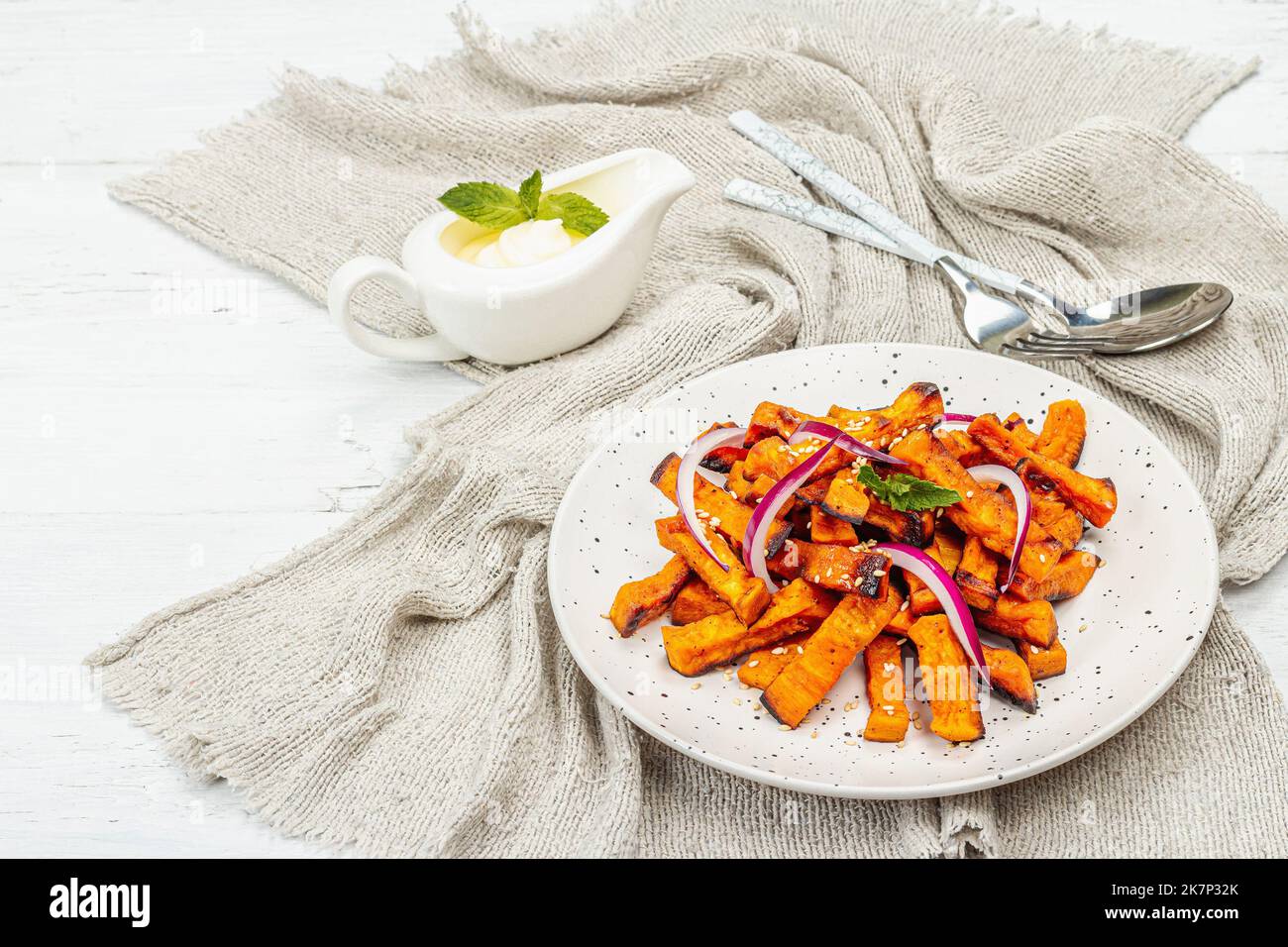 Baked organic batata fries with spices and sauce. Sweet vegetable ...