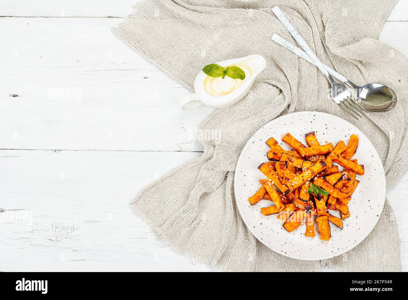 Baked organic batata fries with spices and sauce. Sweet vegetable ...
