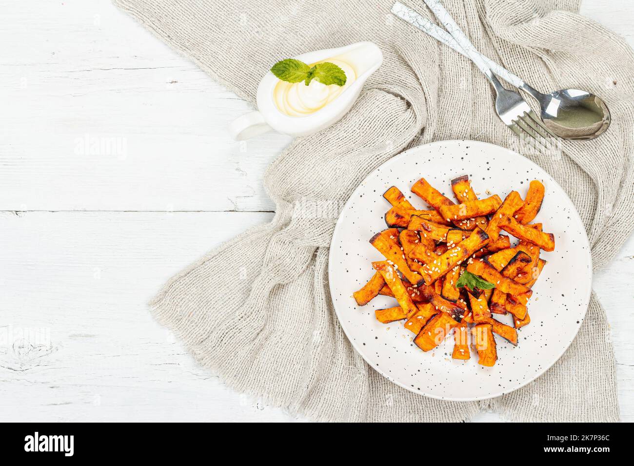 Baked organic batata fries with spices and sauce. Sweet vegetable ...