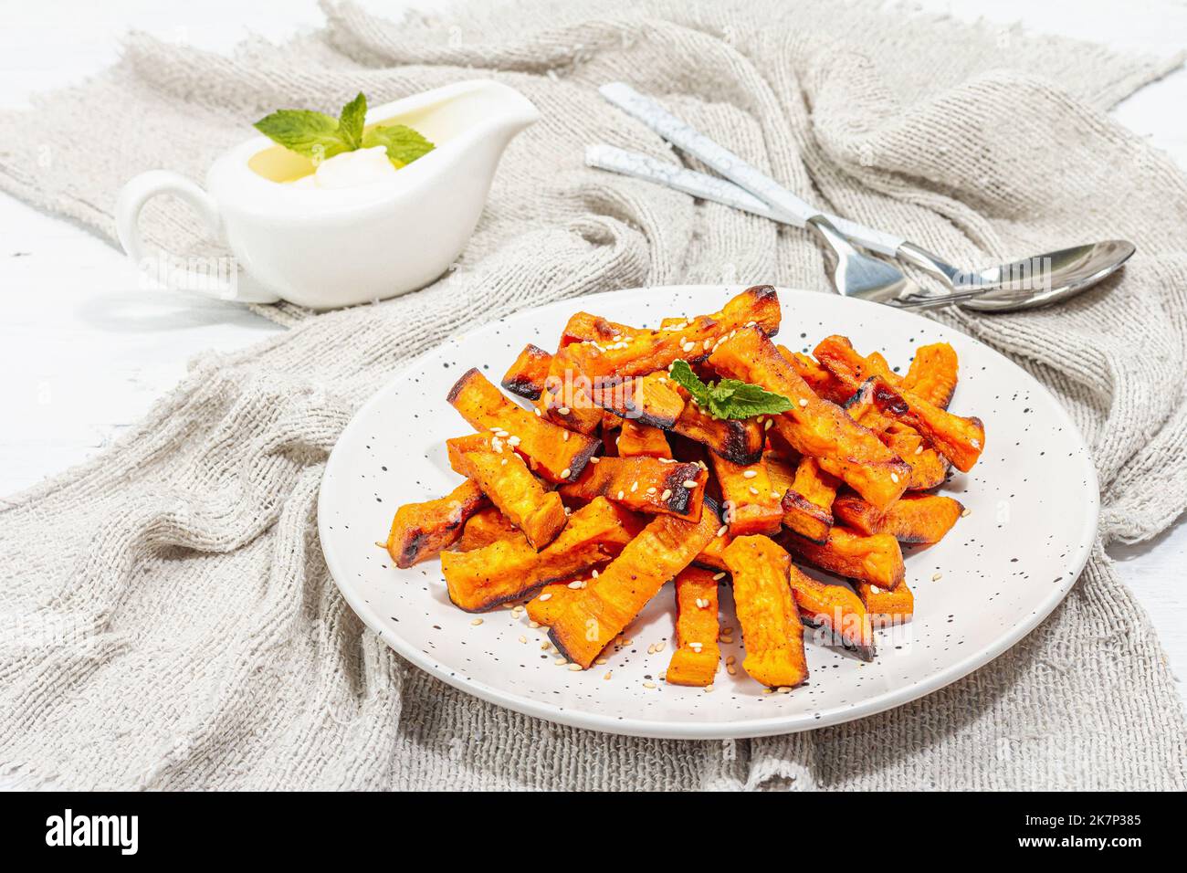 Baked organic batata fries with spices and sauce. Sweet vegetable ...