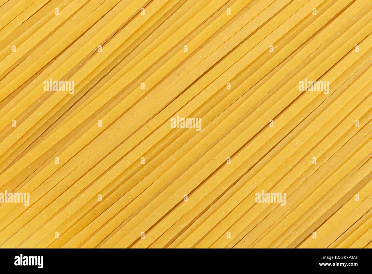 Durum noodles. Close up of raw spaghetti. Full frame fettuccine pasta ...