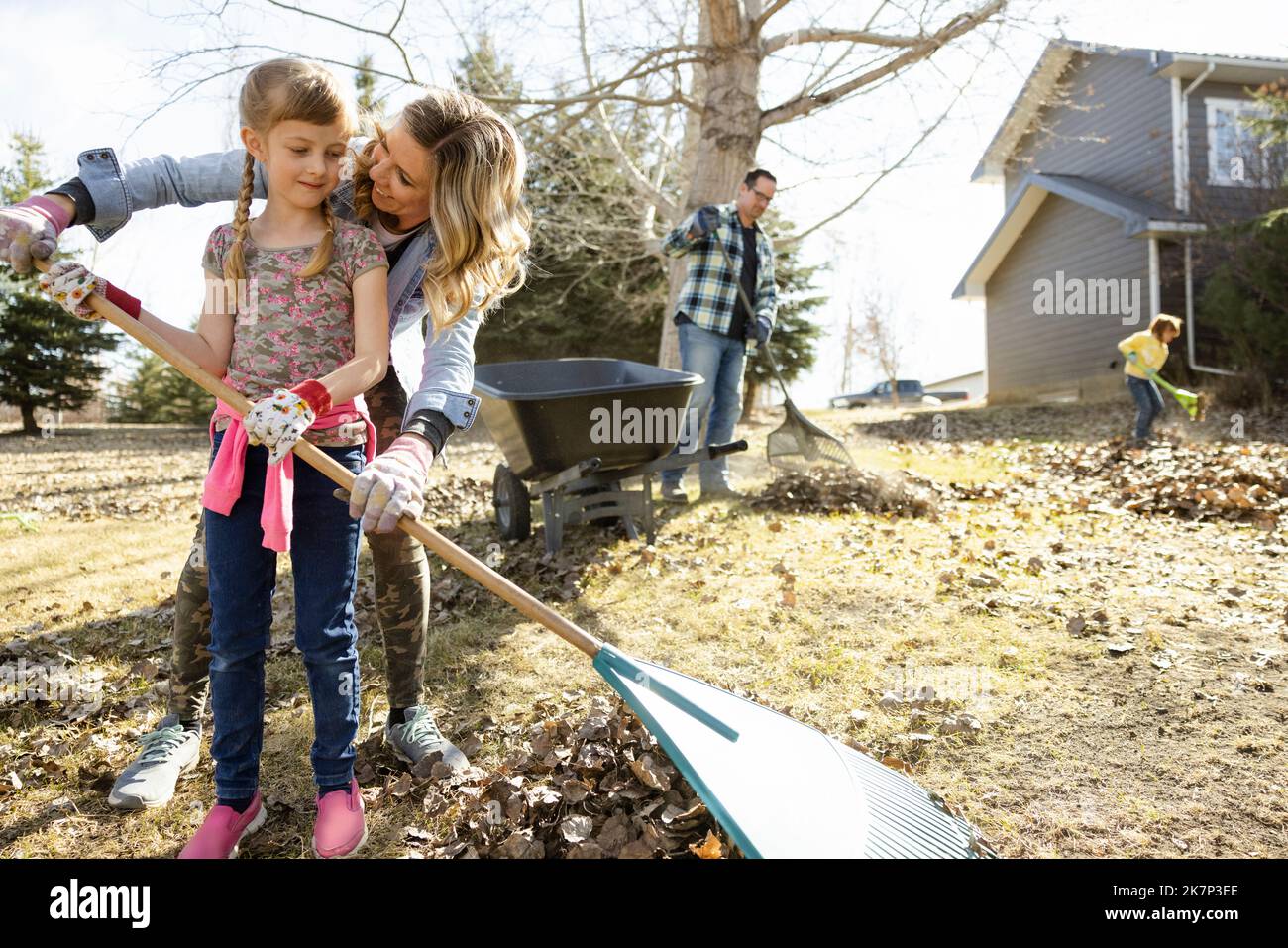 Children gardening with rake hi-res stock photography and images - Alamy