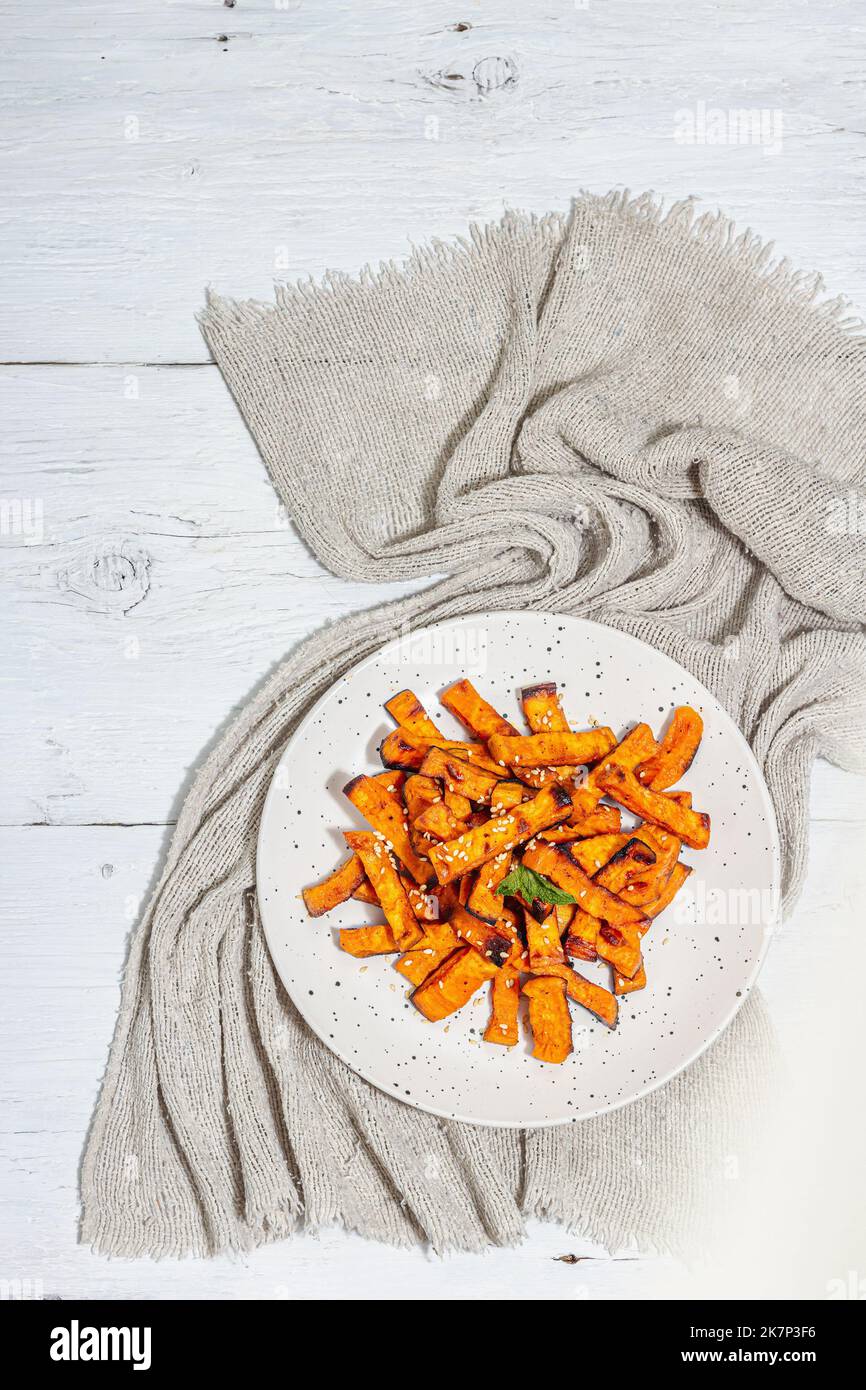 Baked organic batata fries with spices and sauce. Sweet vegetable ...