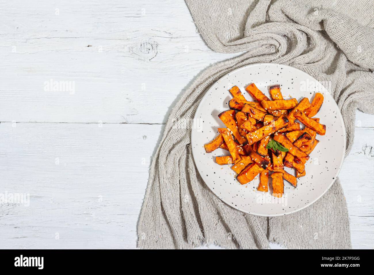 Baked organic batata fries with spices and sauce. Sweet vegetable ...