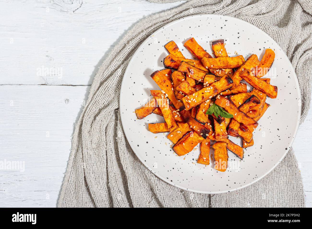 Baked organic batata fries with spices and sauce. Sweet vegetable ...