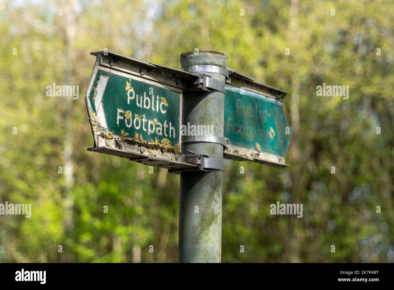 Old green public footpath sign with moss and litchen growing over Stock ...