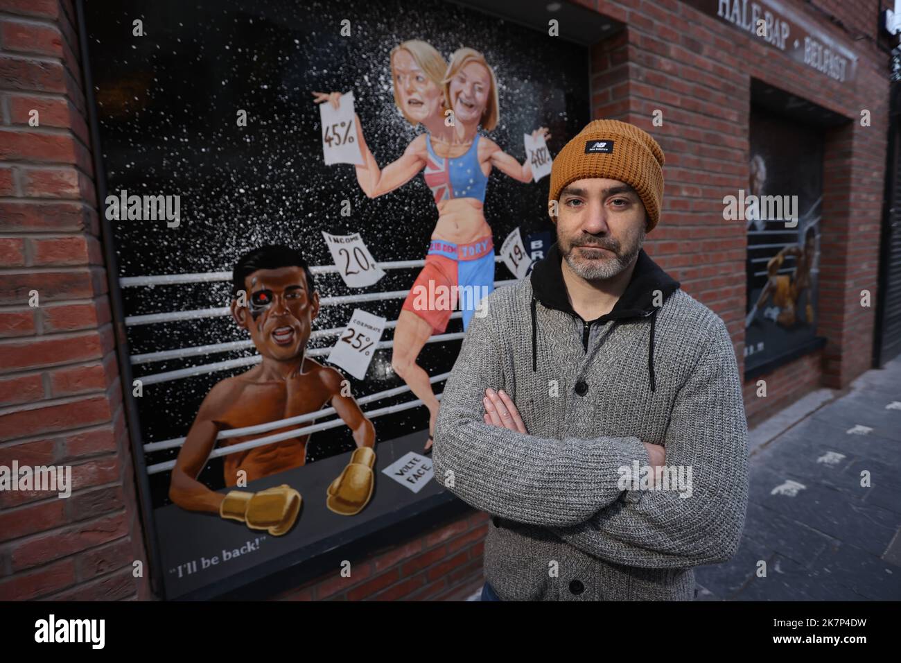 Artist Ciaran Gallagher stands in front of his updated mural of Prime ...