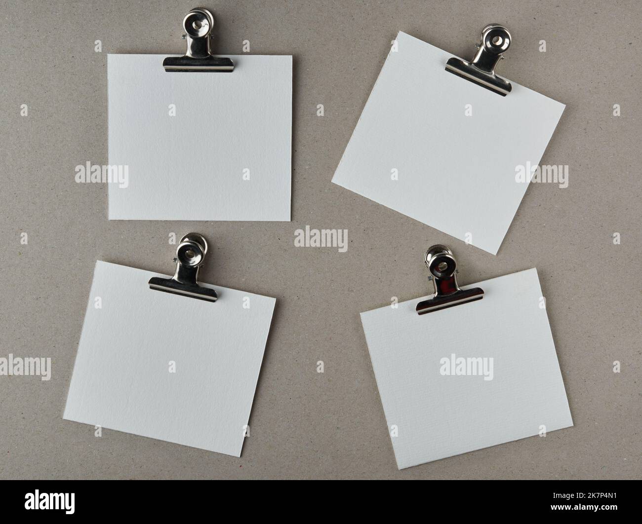 white blank paper notes with metal clips, isolated on gray textured ...