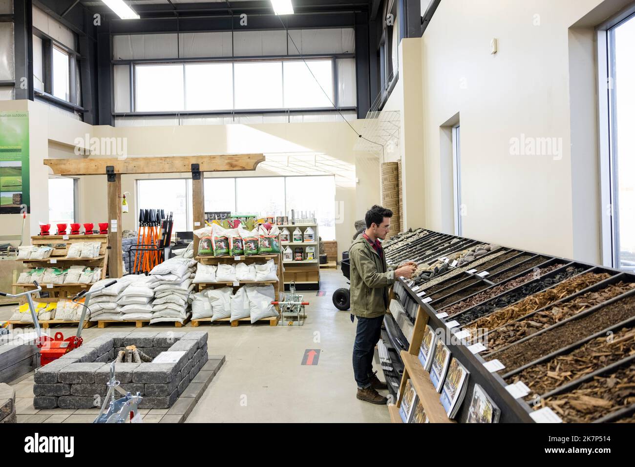 Customer looking at pebbles in home improvement store Stock Photo - Alamy
