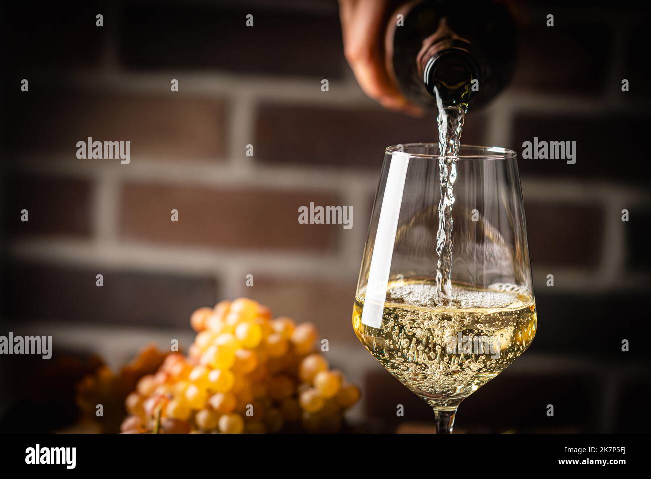 Pouring white wine Stock Photo - Alamy