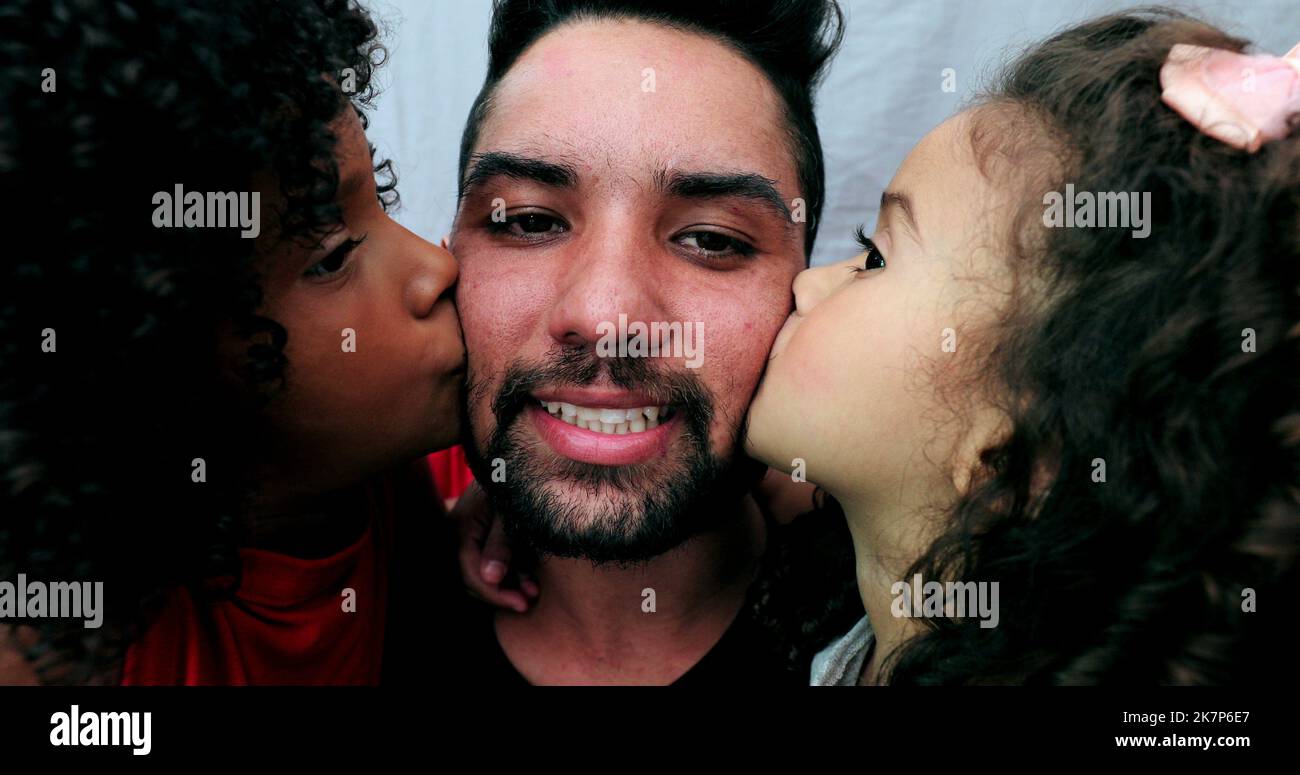 Hispanic father kissed by two daughters. latin south american people ...