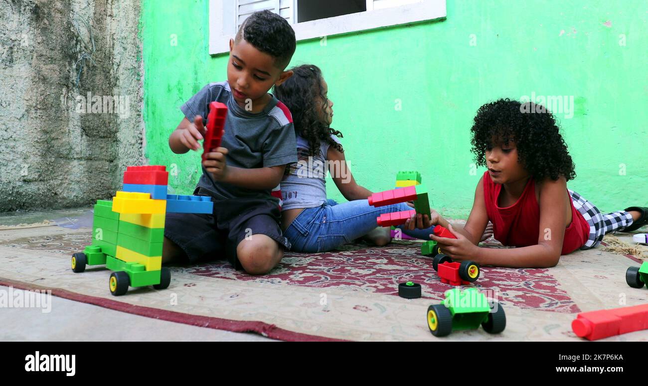 Hispanic latin kids playing with toys outside Stock Photo - Alamy