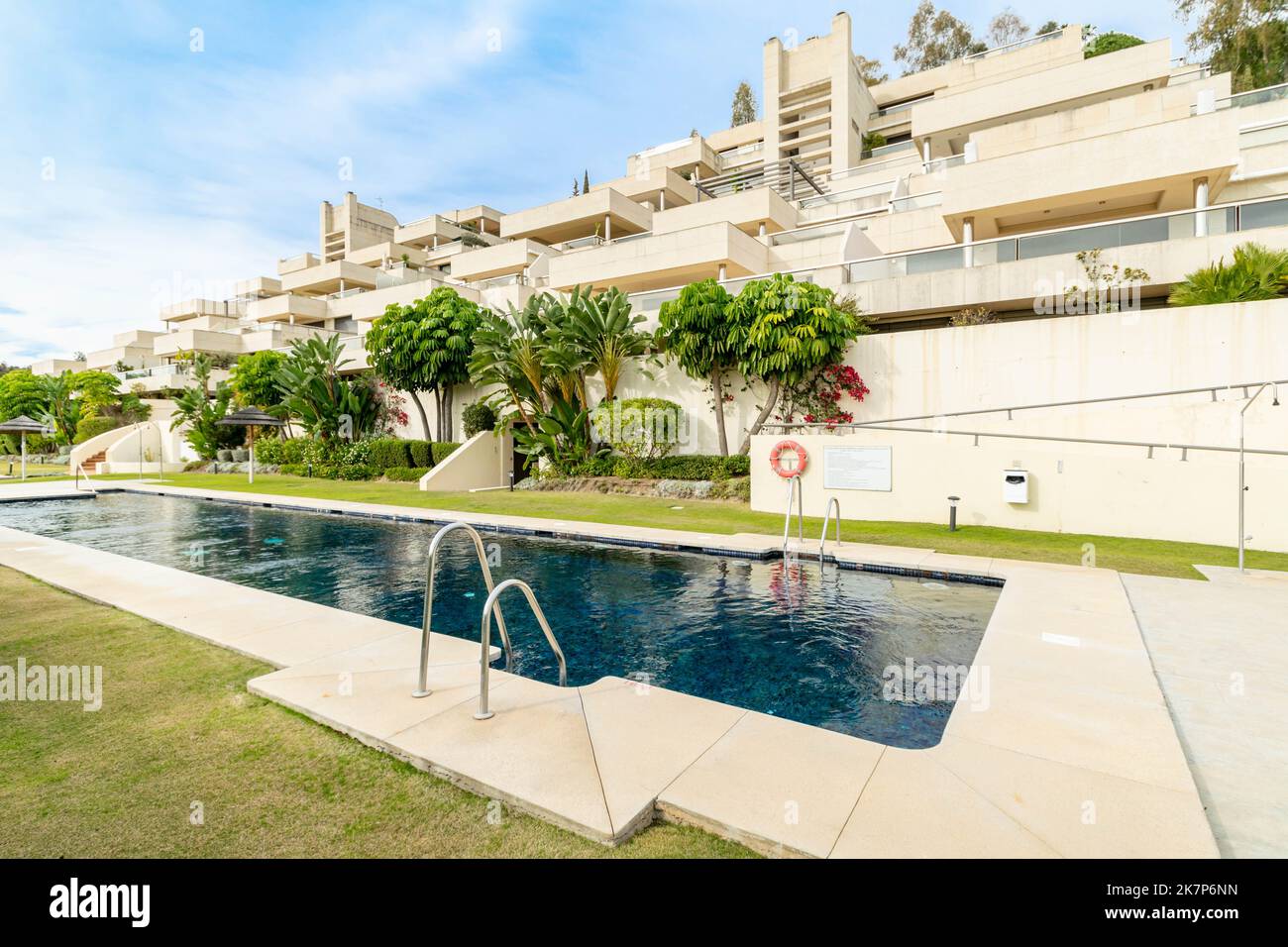 a poolside view of a public pool of an apartment complex along the ...