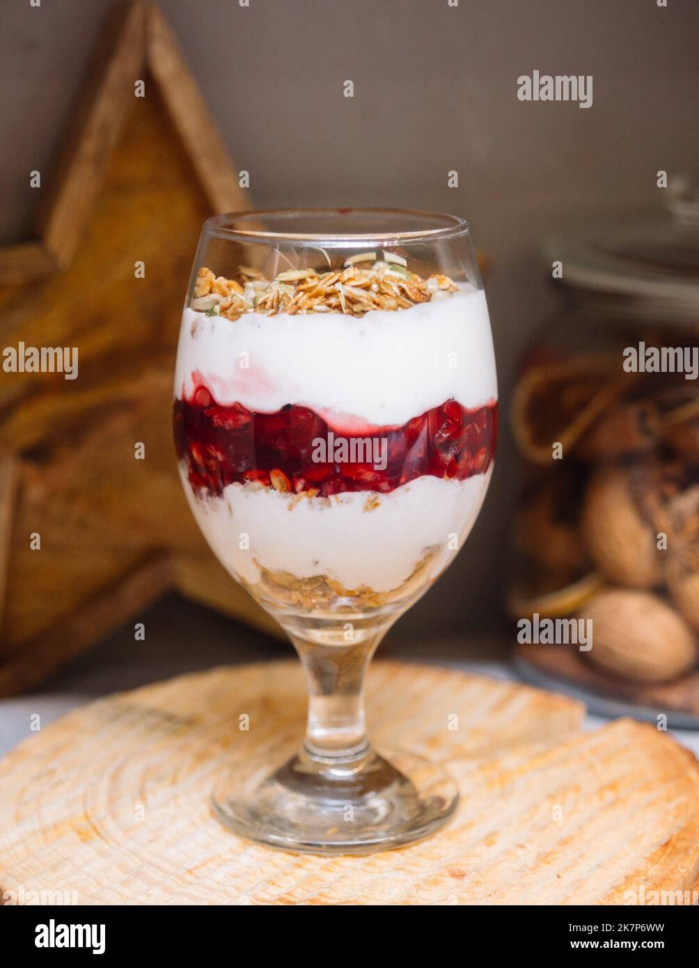 Cherry yoghurt parfait with crispy granola on top in a wine glass Stock ...