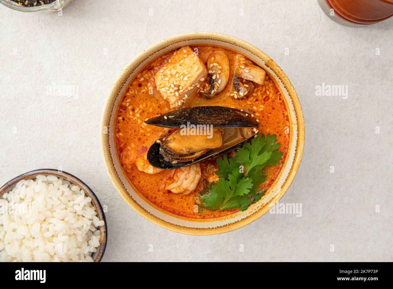 Tom yam seafood soup with rice Stock Photo - Alamy