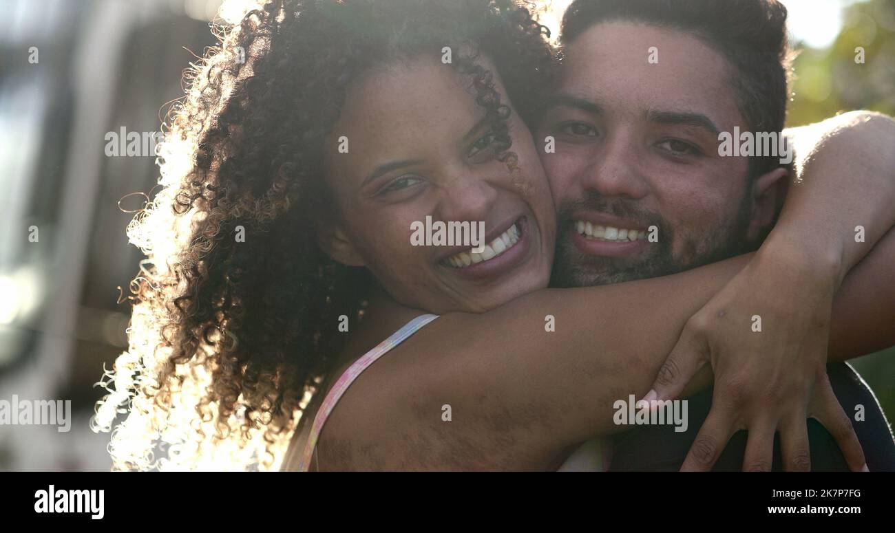 Hispanic couple embrace. Brazilian man and woman hugging and kissing ...