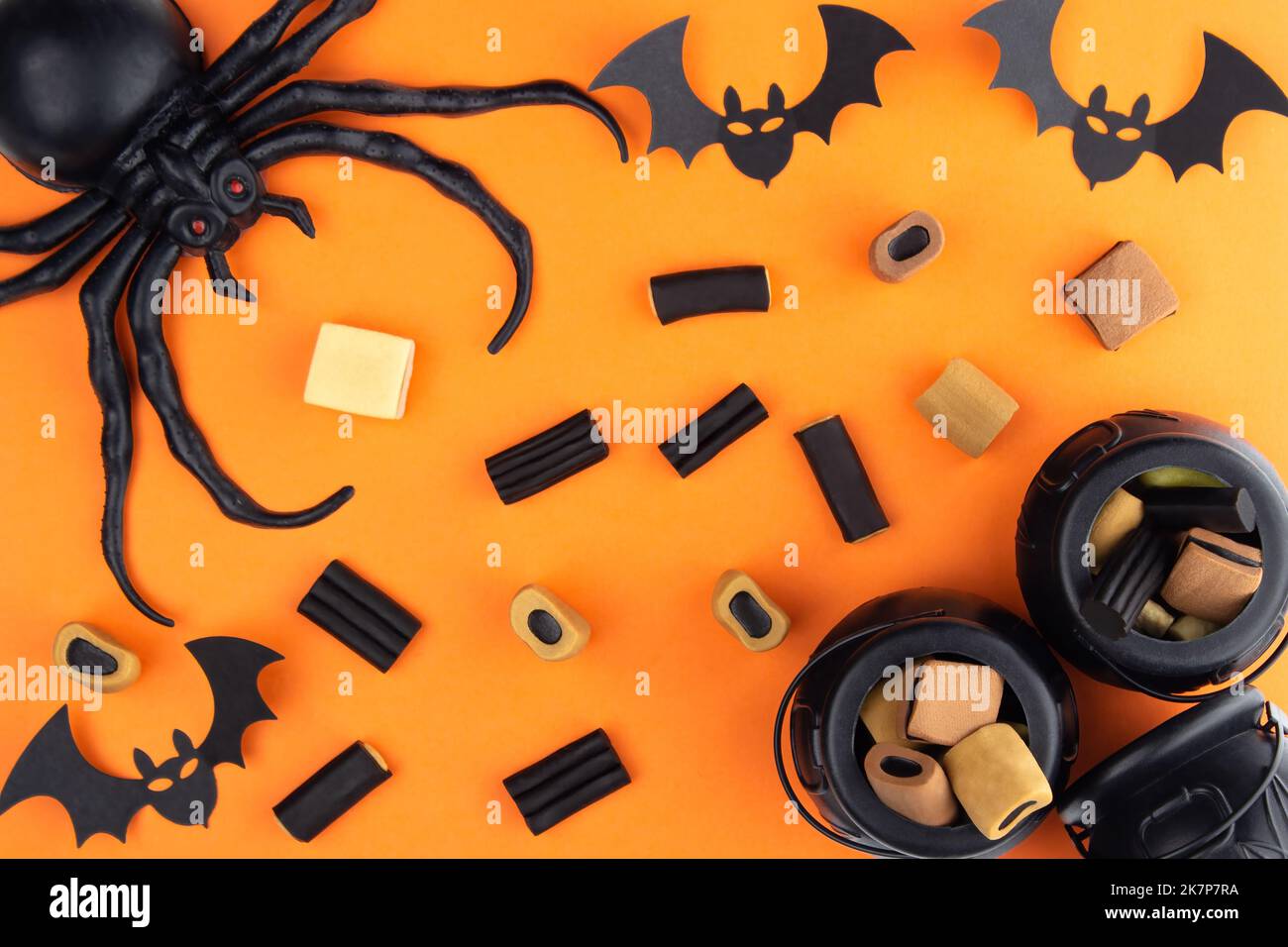 On an orange background, the composition to Halloween. A spider sits in ...