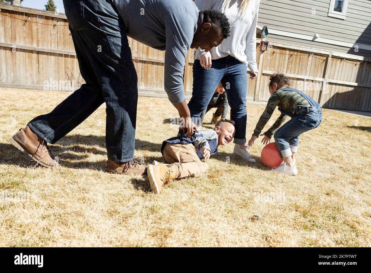 Father tickling son on backyard lawn Stock Photo - Alamy Father tickling son on backyard lawn Stock Photo - Alamy