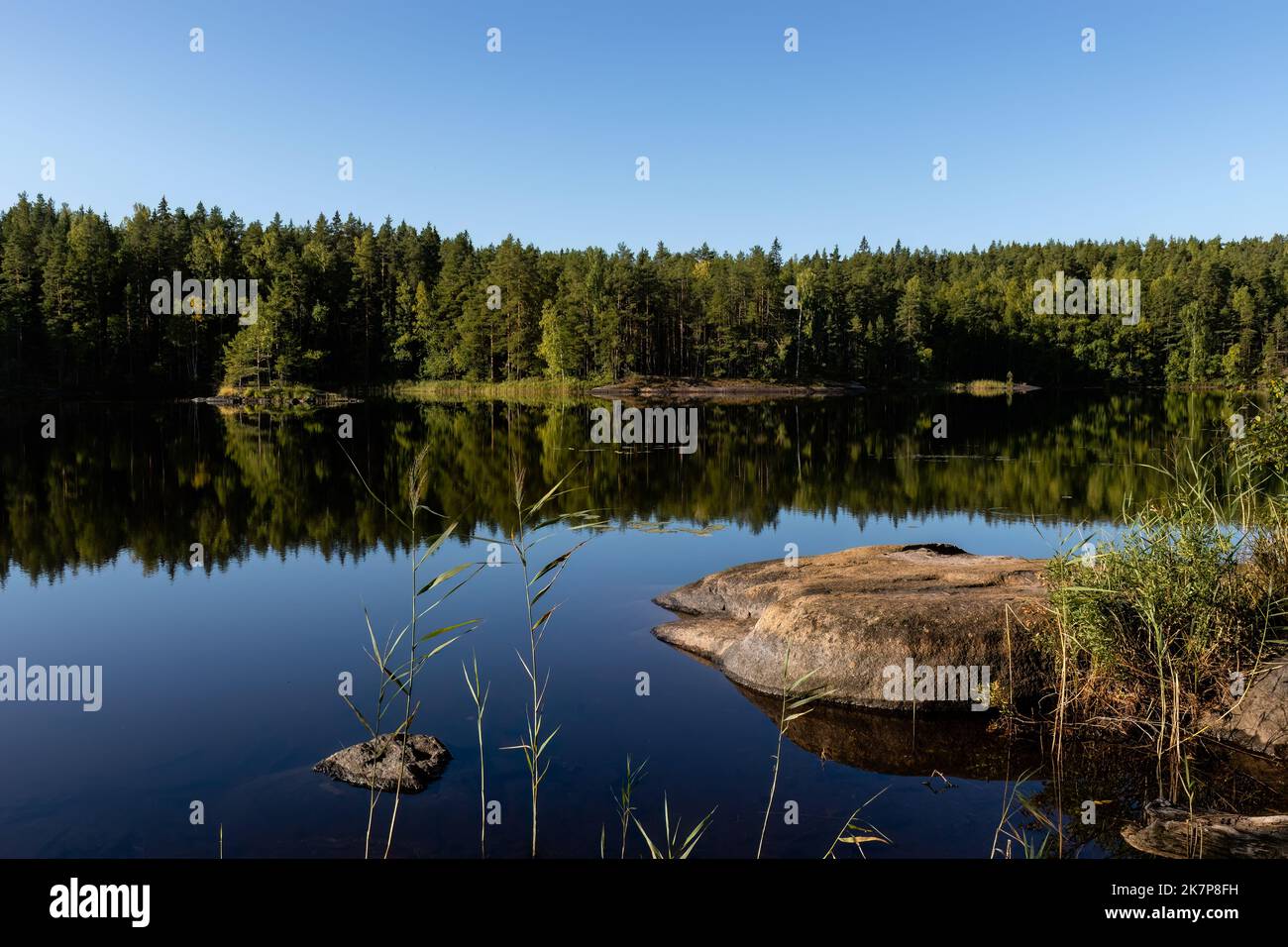 Beautiful Finnish lake view with the reflection from calm water in ...
