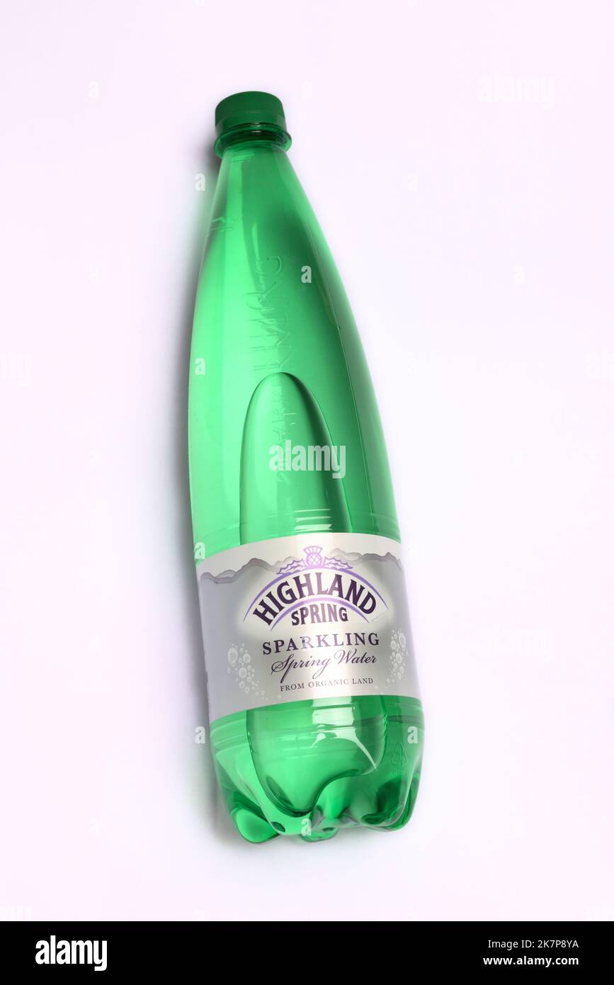 A plastic bottle of Highland Spring sparkling water on a white/neutral ...