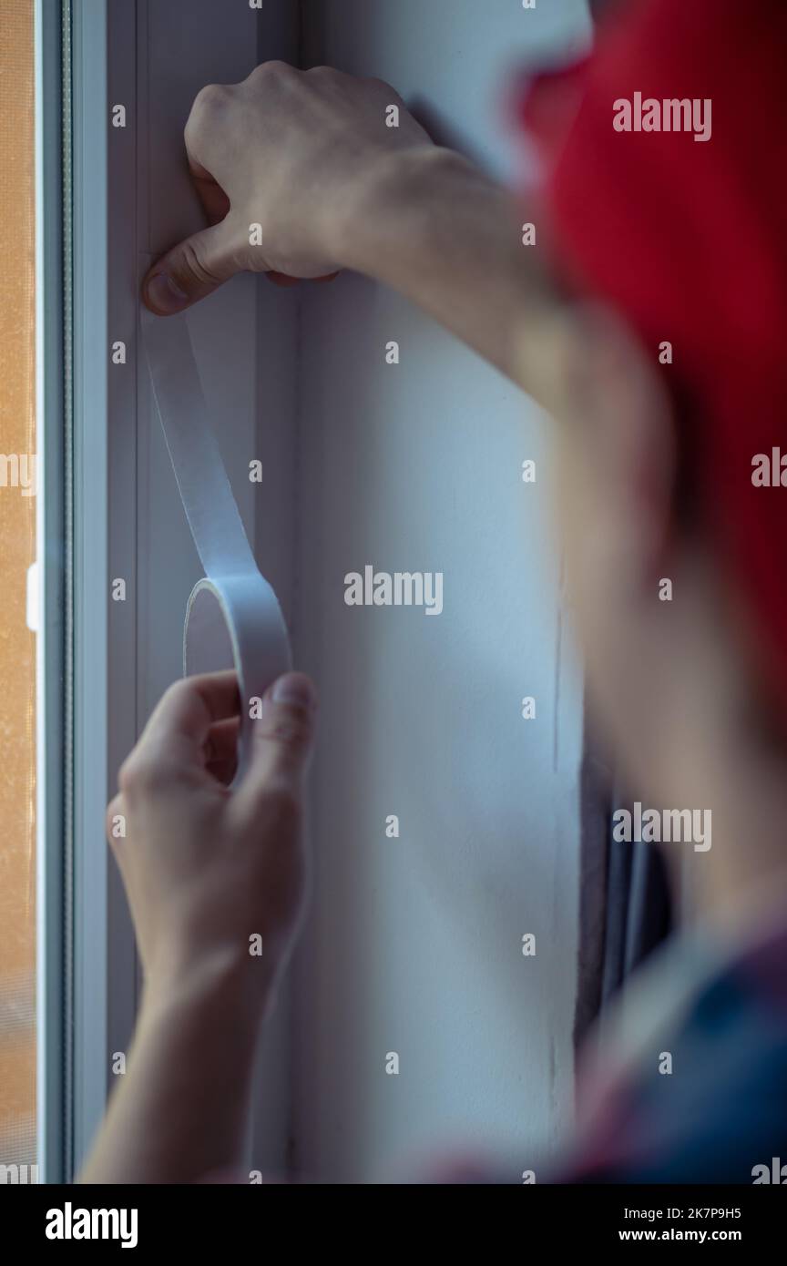 Skilled serviceman sealing the plastic steel window Stock Photo - Alamy