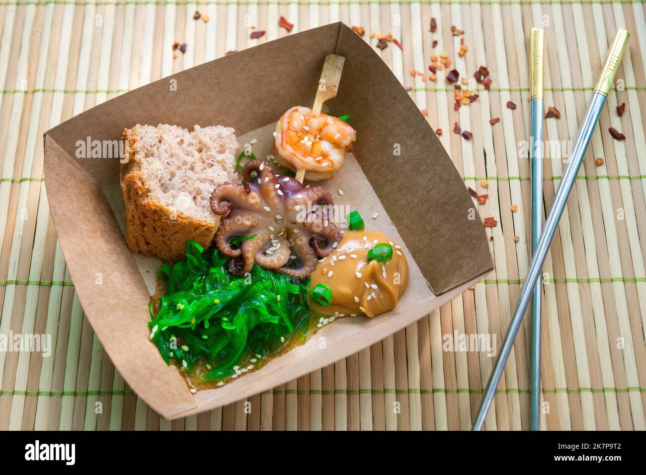 Paper plate with a portion of seafood, shrimp, octopus, Chuka seaweed ...