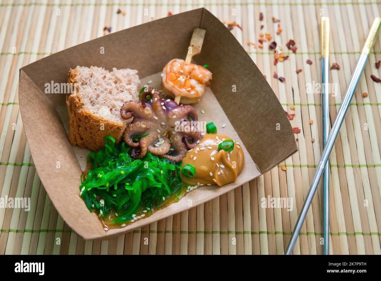 Paper plate with a portion of seafood, shrimp, octopus, Chuka seaweed ...