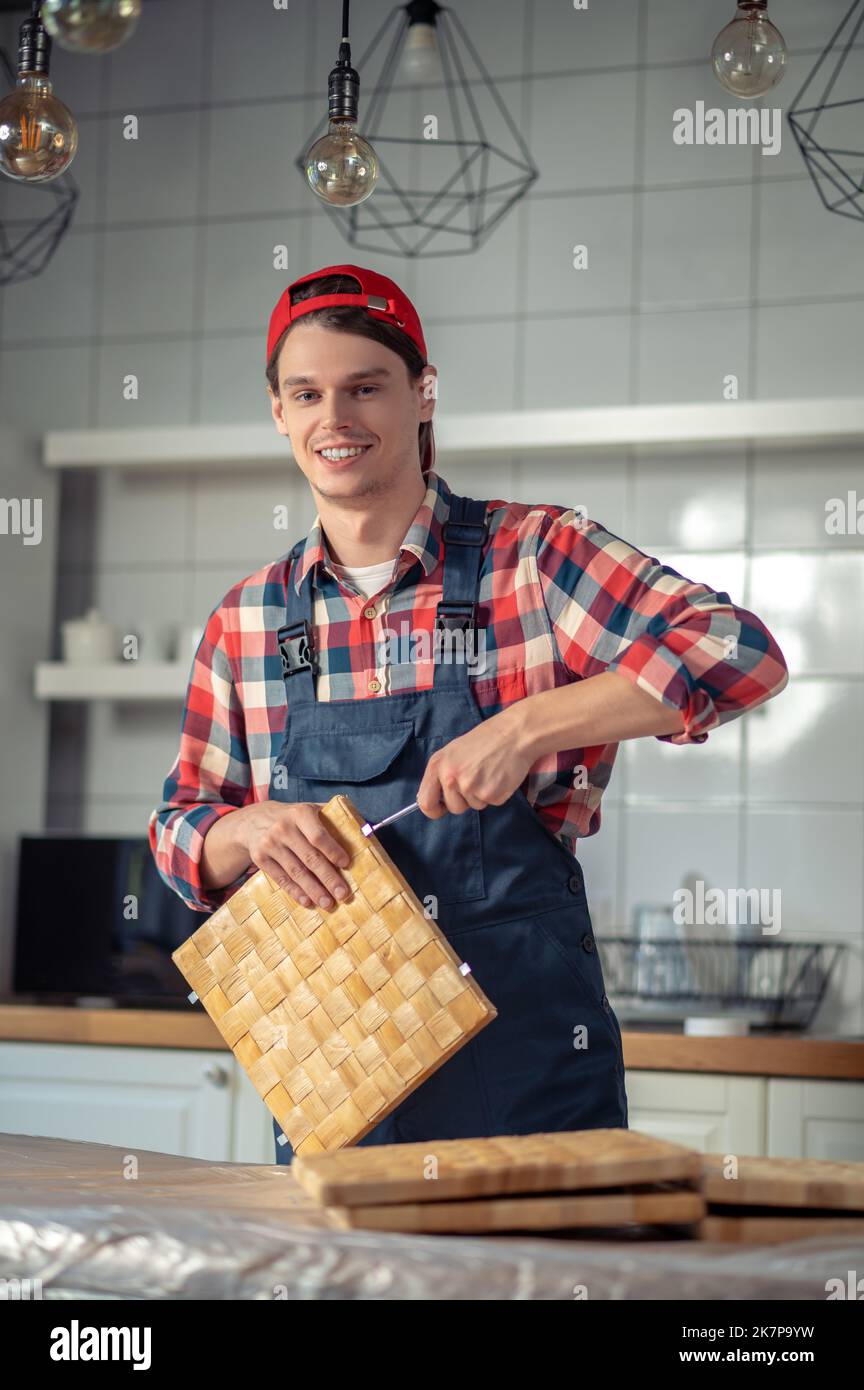 Pleased carpenter making a straw box in the kitchen Stock Photo - Alamy