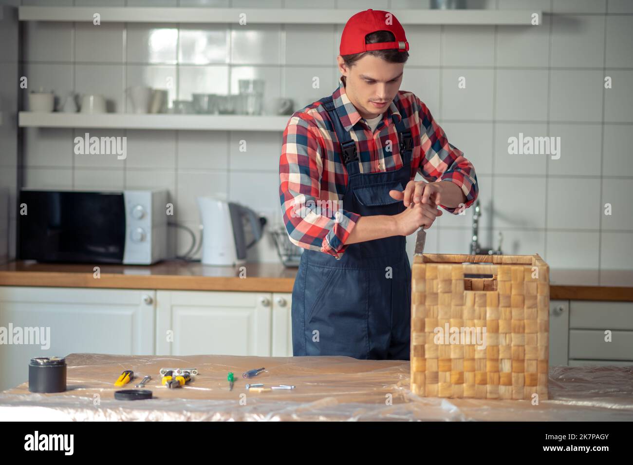 Focused woodworker chiseling off the dried excess glue Stock Photo - Alamy