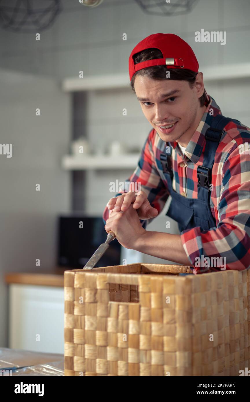 Young carpenter engaged in making a wooden box Stock Photo - Alamy