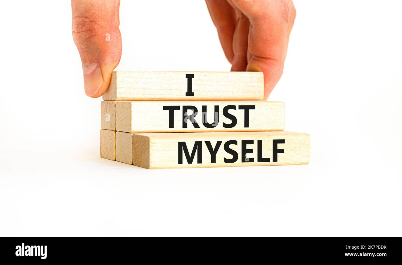 I trust myself symbol. Concept words I trust myself on wooden blocks. Businessman hand ...