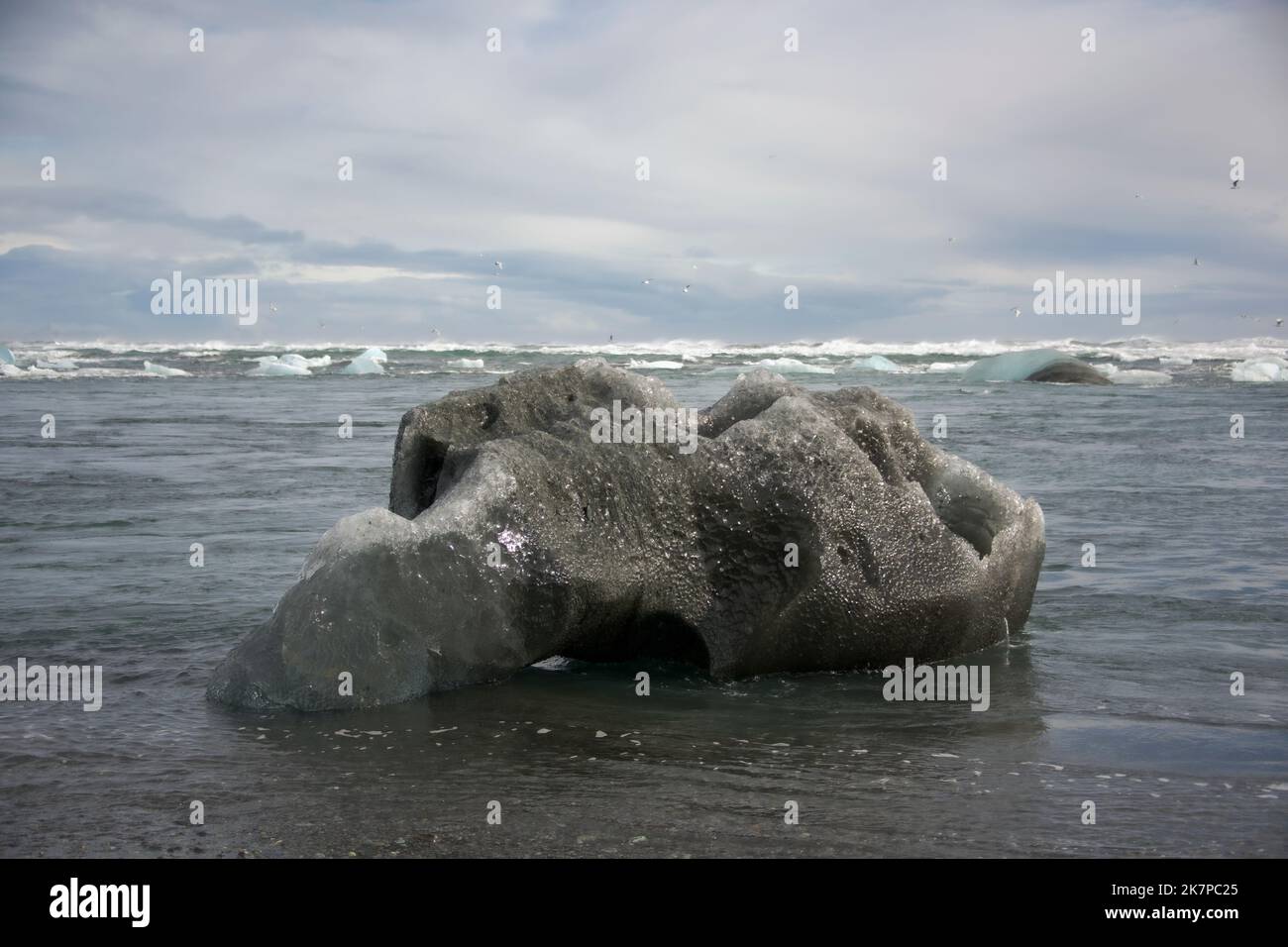 Stormy sea with black iceberg at edge of Diamond Beach, Iceland Stock ...