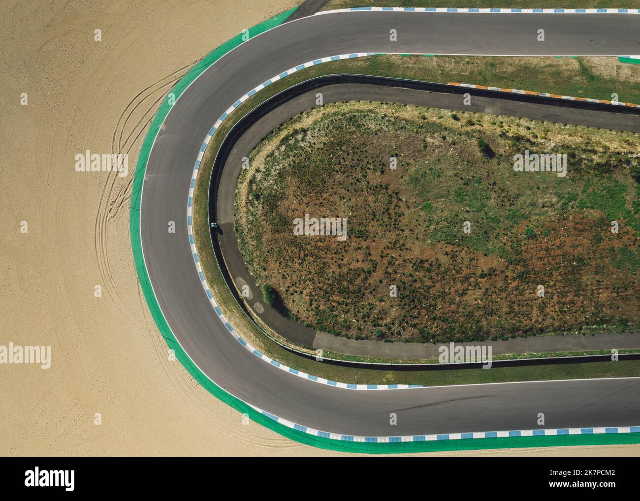 Aerial top down drone view of an empty racing track with tight turns ...