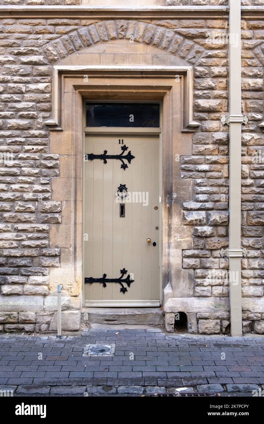 Beige door with wrought iron hinges (Oct22 Stock Photo - Alamy
