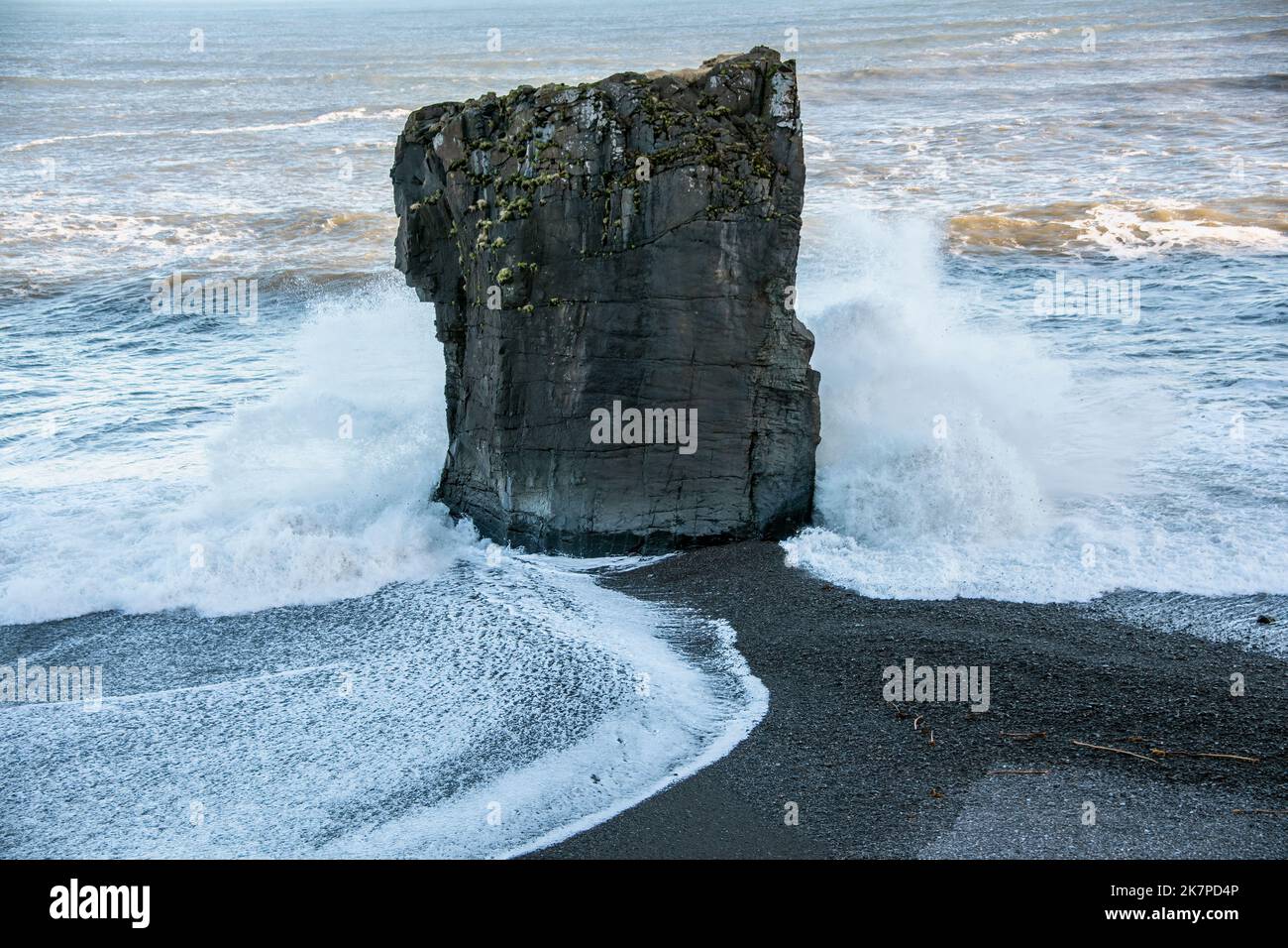 Large wave hitting black basaltic pillar, Laekjavik, East Fjords ...