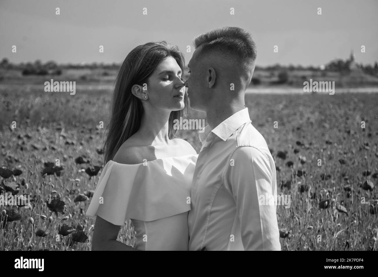 couple in love. man and woman in poppy field. summer flower meadow ...