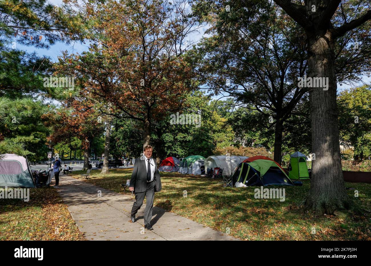 A man walks through the homeless encampment in the Foggy Bottom section ...