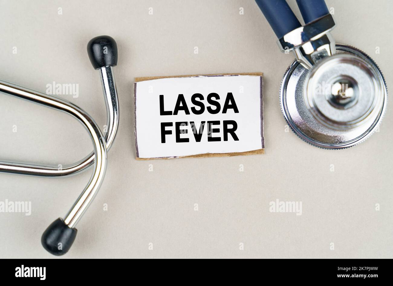 Medical concept. On a gray background, a stethoscope and a cardboard ...