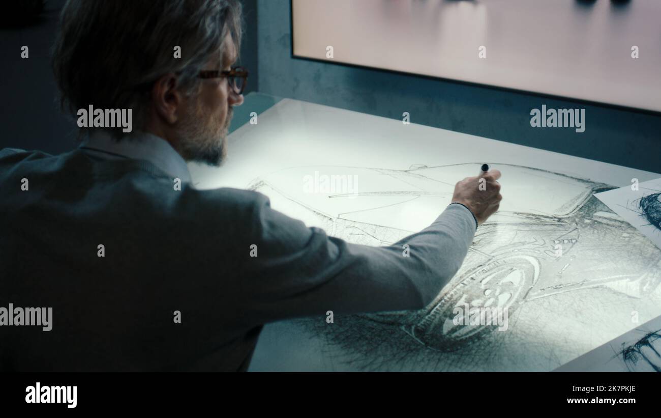 Automotive graphic designer draws sketch of the prototype model of a ...