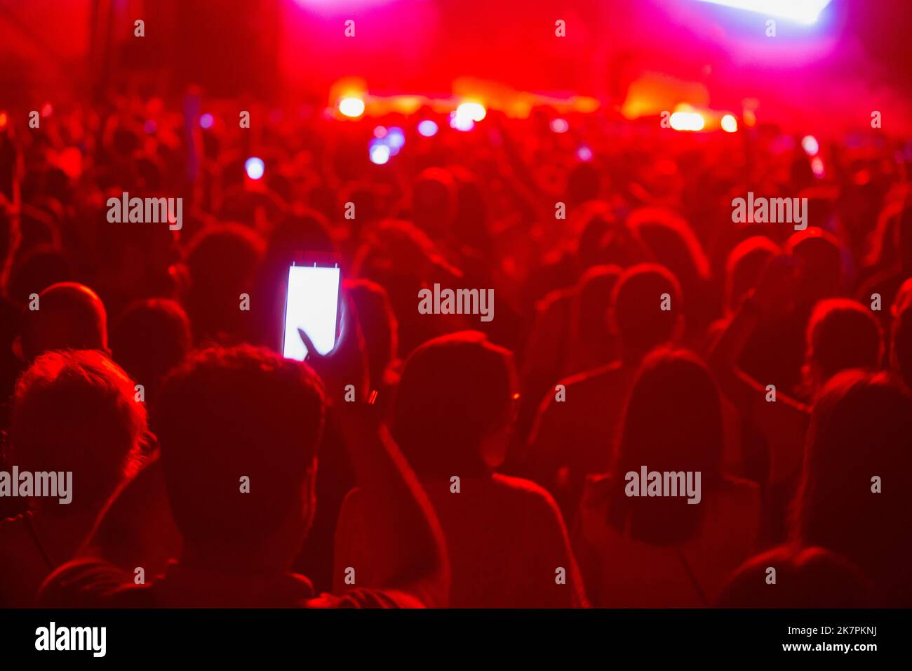 People with mobile phones at a concert. Hands with mobile phone. public ...