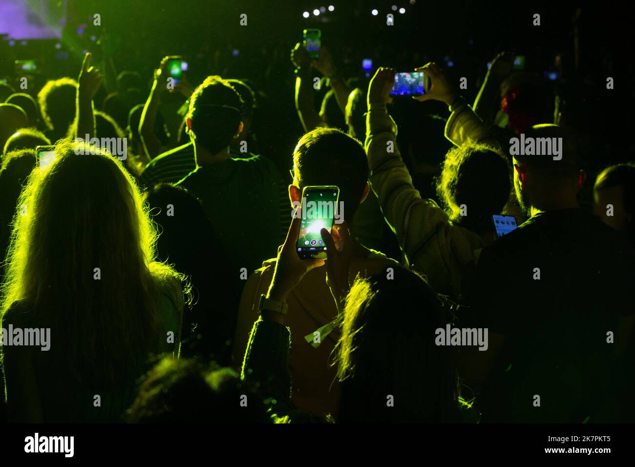 People with mobile phones at a concert. Hands with mobile phone. public ...