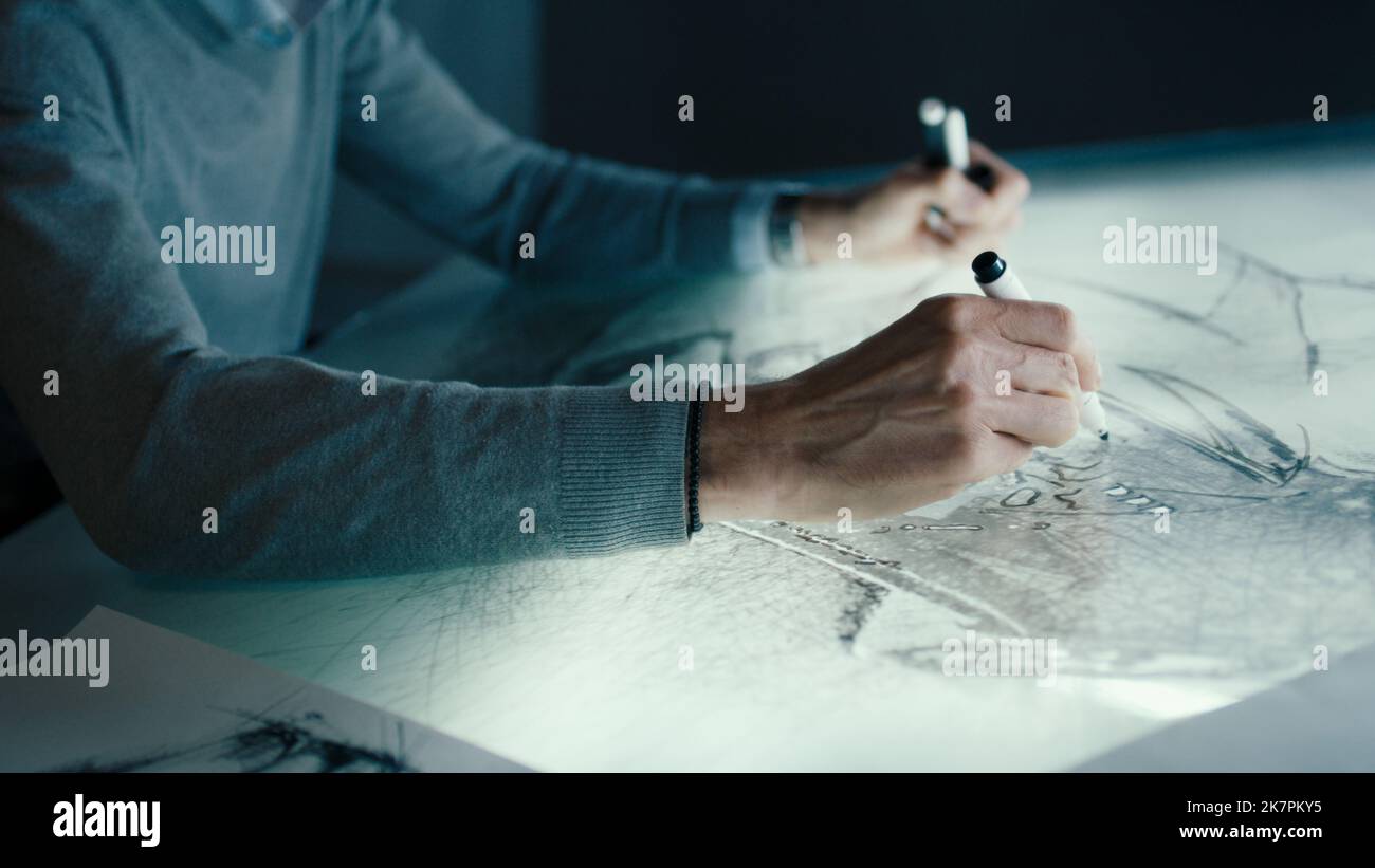 Closeup hands of a senior automotive graphic designer works with ...