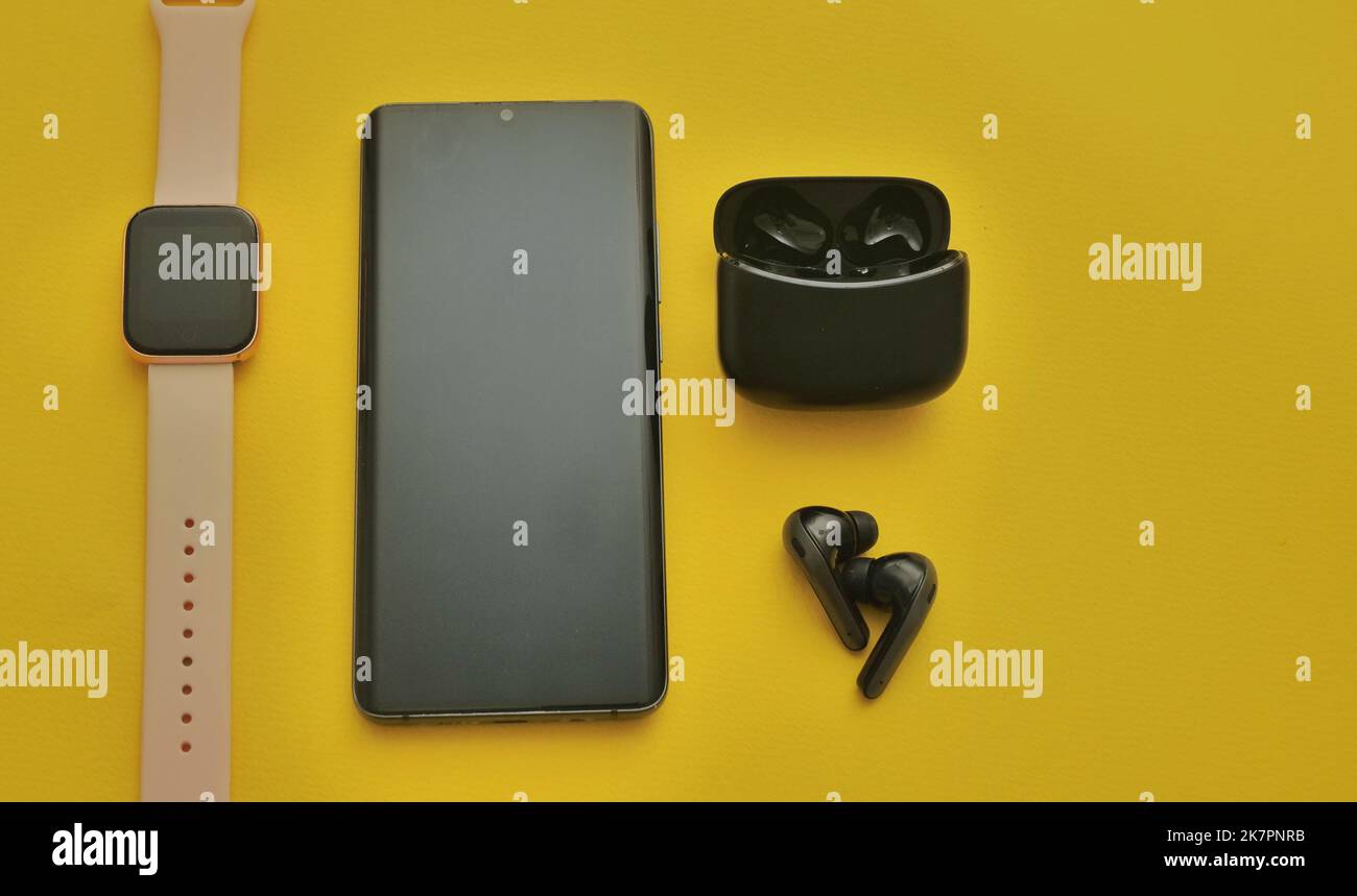 Smartphone with headphones on a yellow background. Listen to music ...