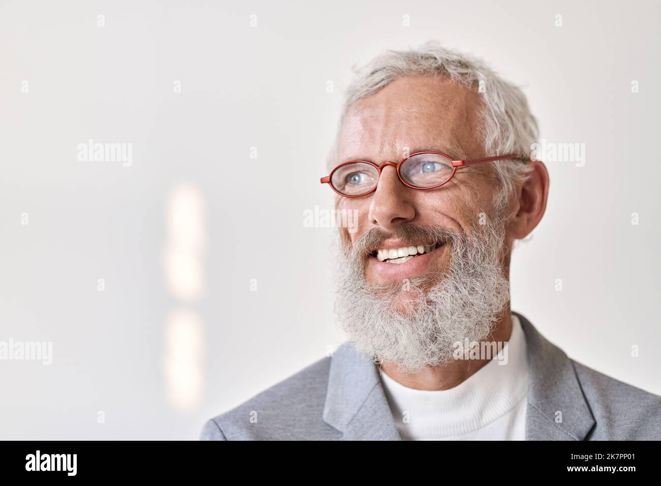 Smiling senior old business man looking away isolated on white wall ...