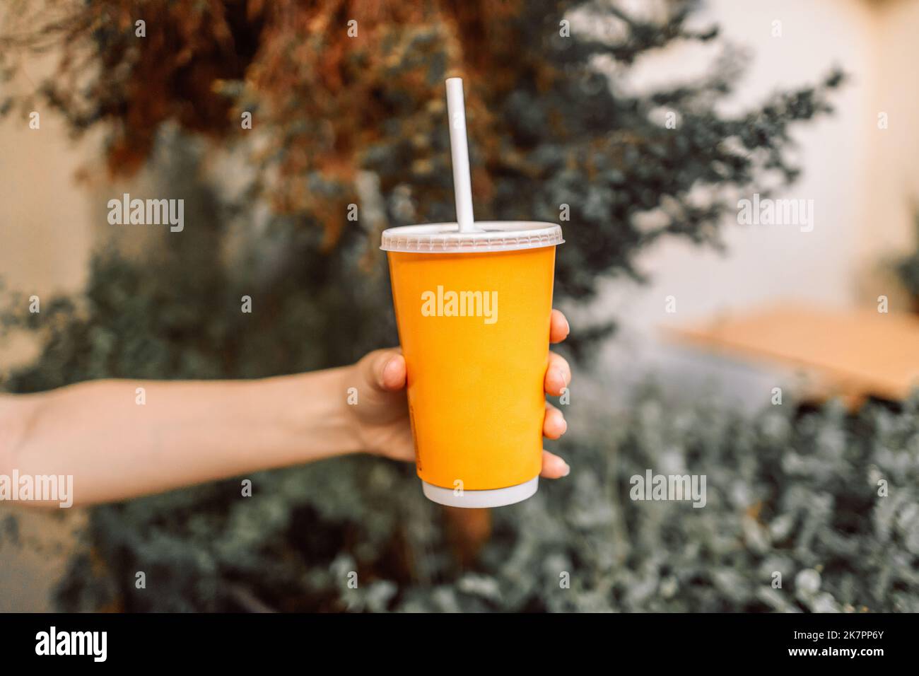 Woman hand holding plastic cup with drink at city street Stock Photo ...